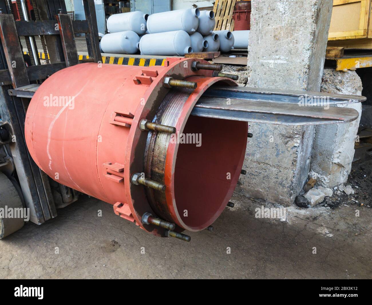 Red gland expansion joint for heating main on concrete floor. Heat and ...