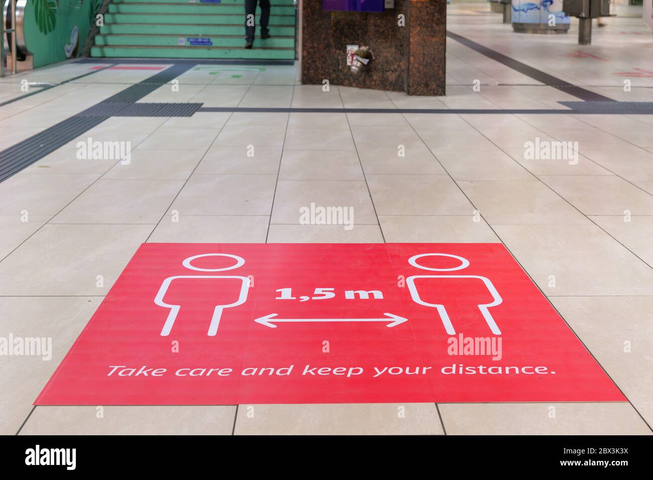 Keep your distance on red rectangular caution sign on the floor inside ...