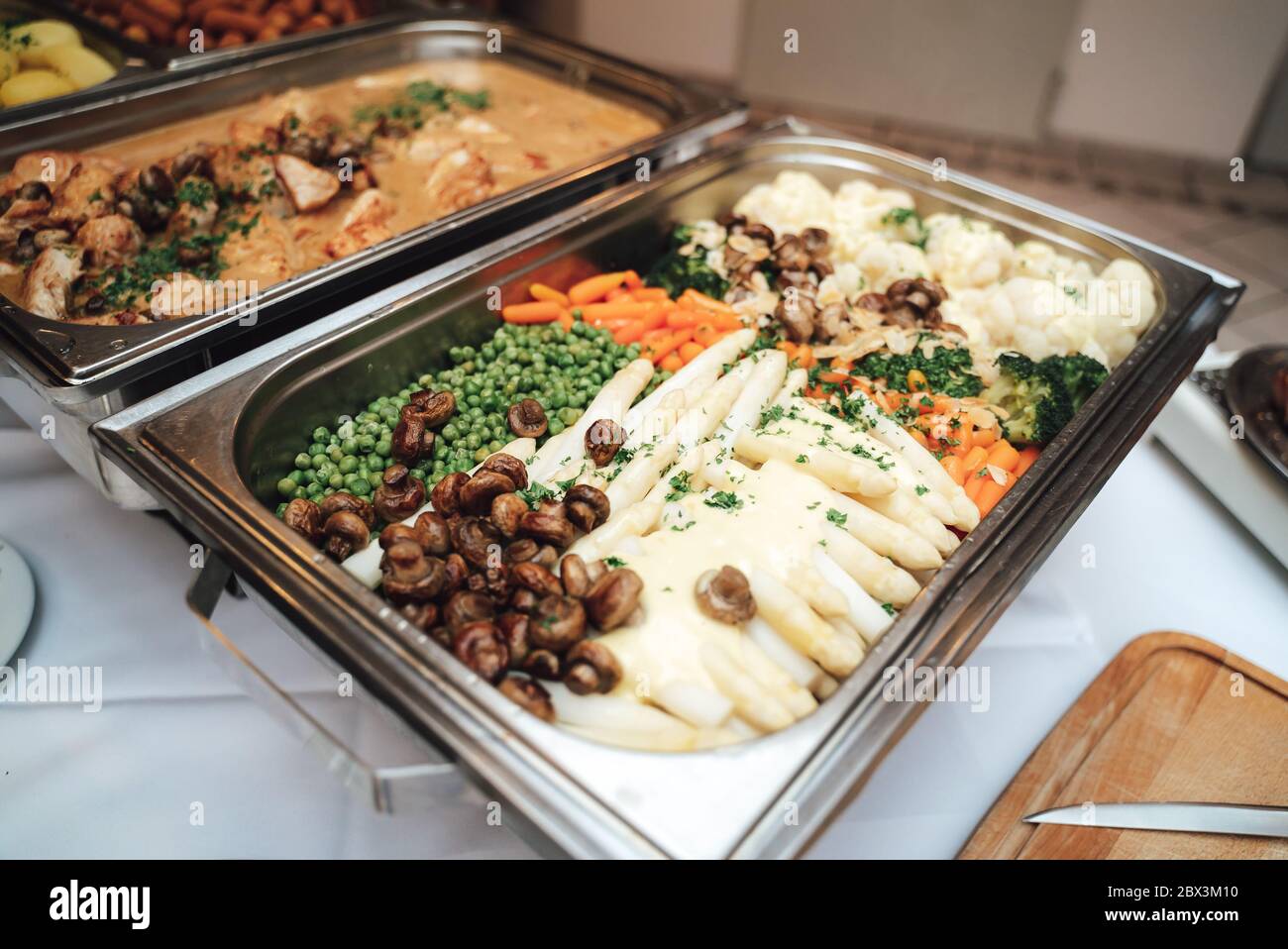 Stainless self-service buffet table with various meals, side dishes and ...