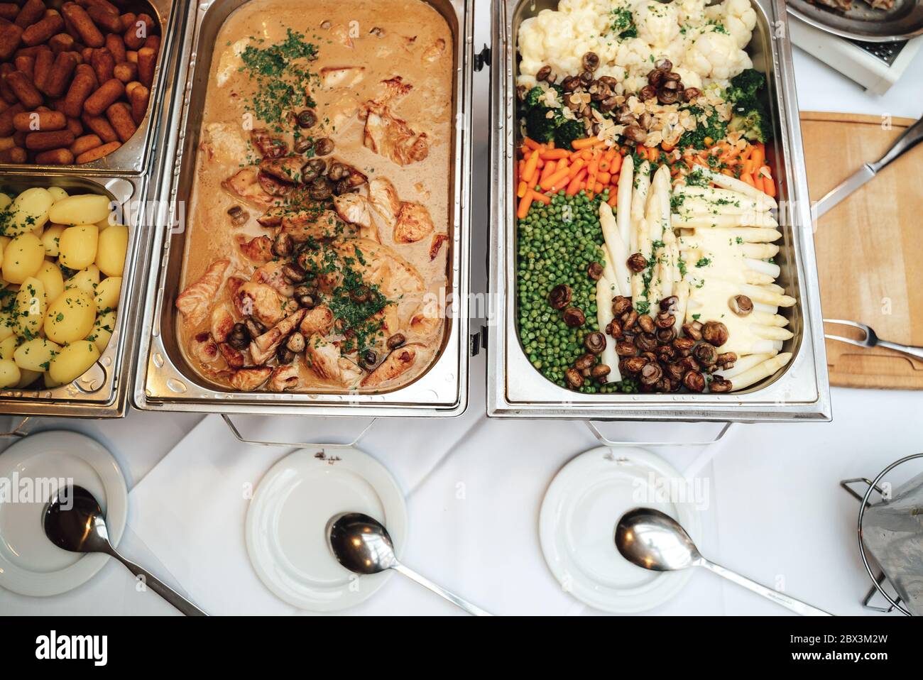 Top view of stainless self-service buffet table with various meals ...