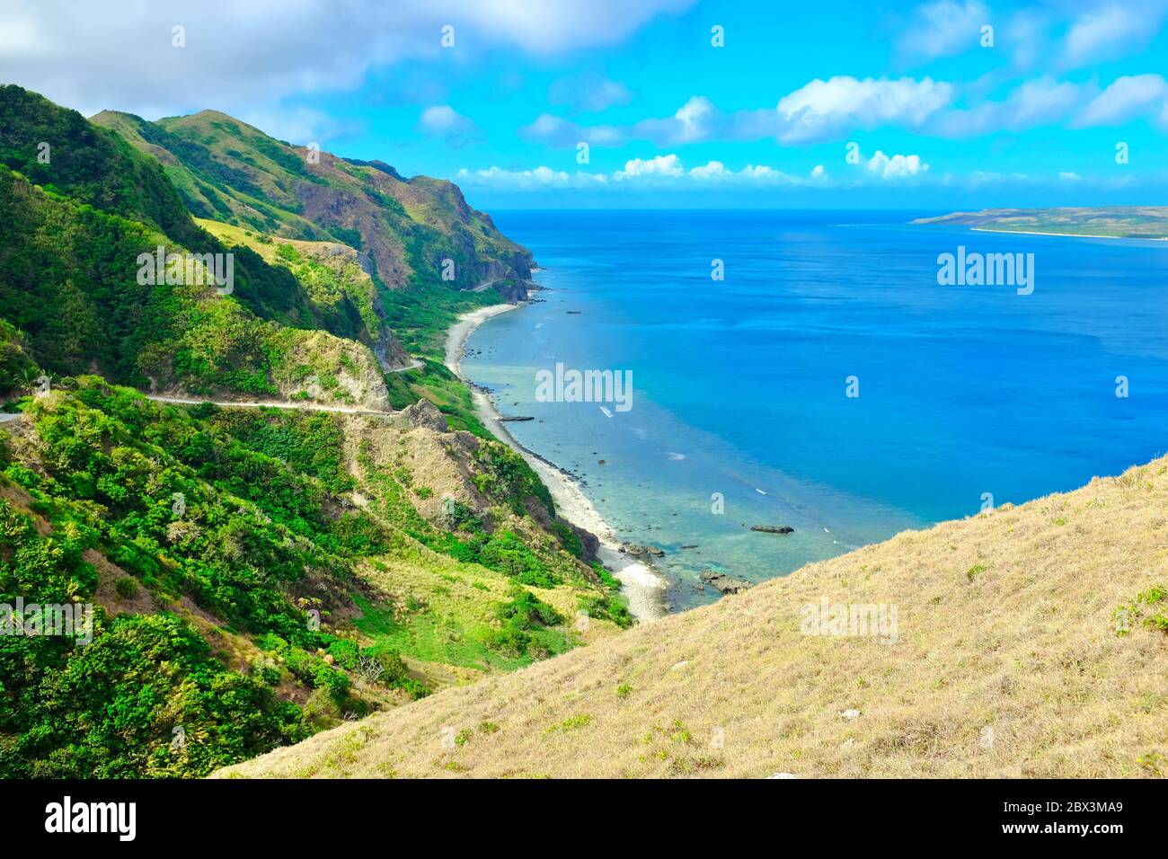 Lush green mountain and hills and bright blue sea and sky in Sabtang ...
