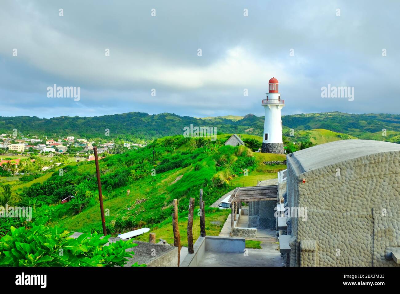 Basco lighthouse with lush greenery on top of Naidi hills in Basco ...