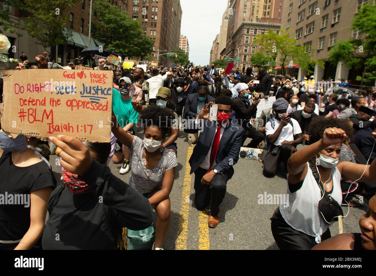 New York City, USA, 06/04/2020 . Marchers take a knee for a moment of ...