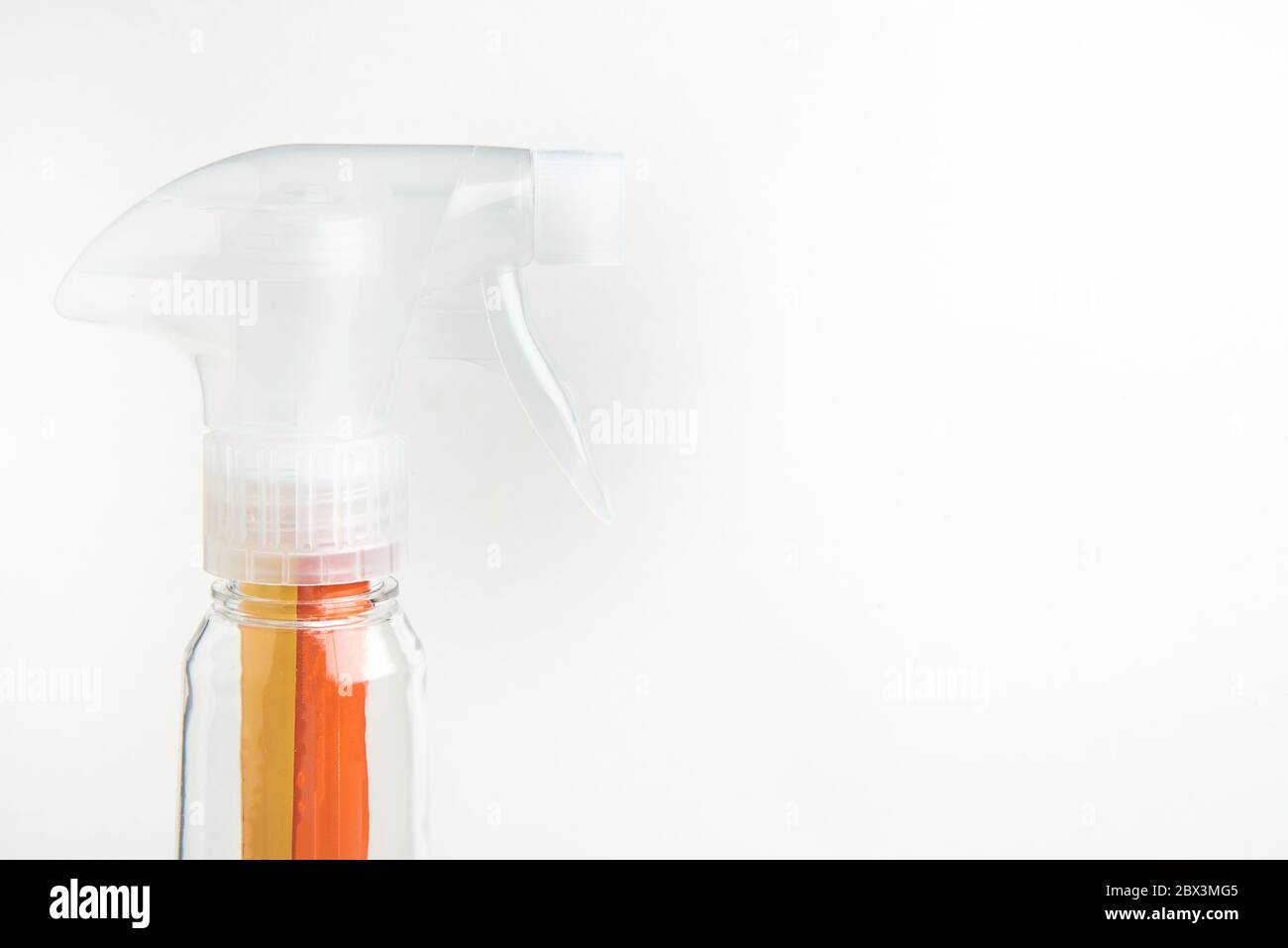 A close-up of the top portion of a transparent nozzle liquid spray ...