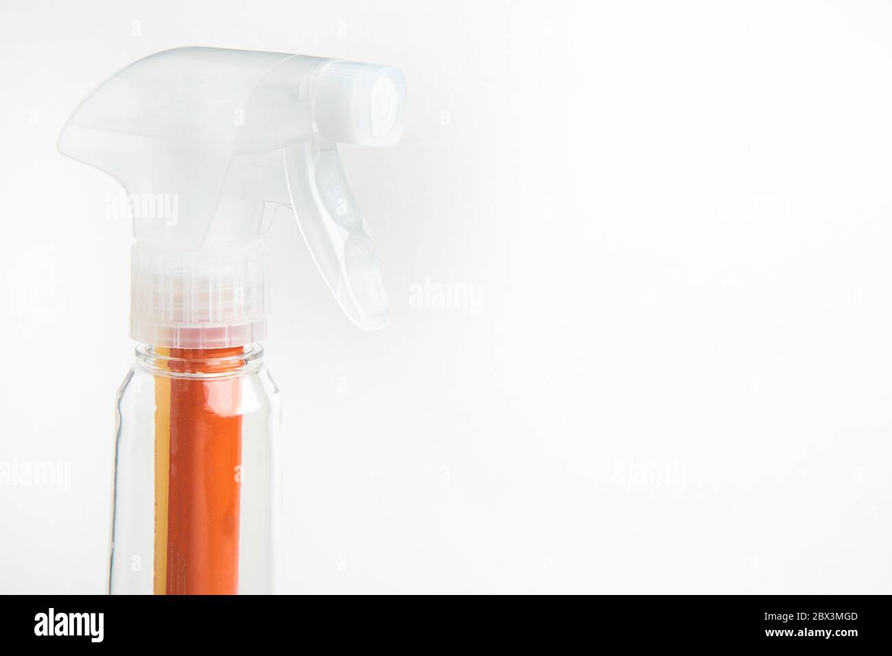 A close-up of the top portion of a transparent nozzle liquid spray ...