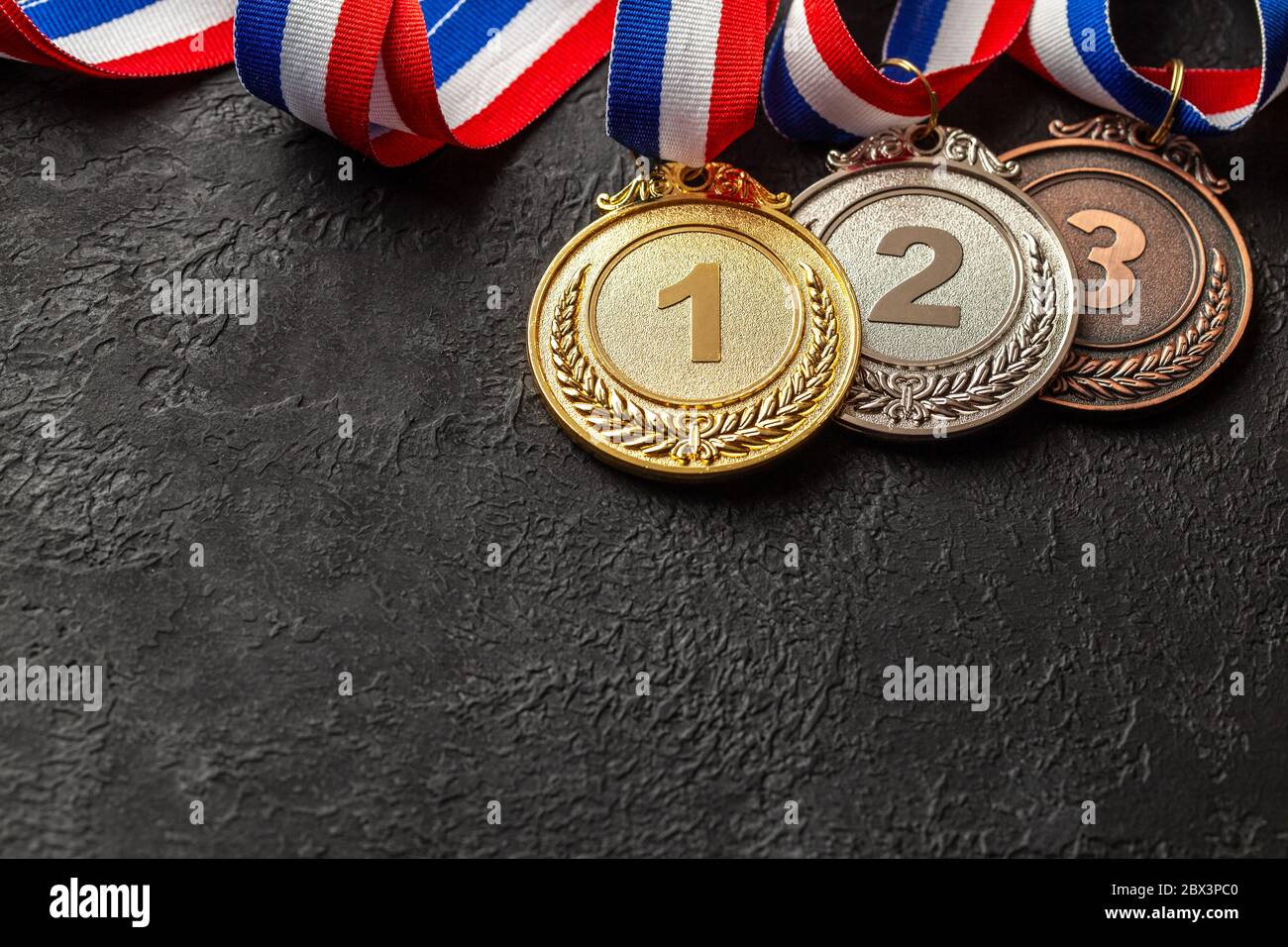 Gold, silver and bronze medal with ribbons. Award for first, second and ...