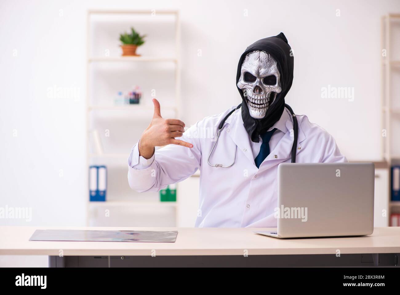 Male devil doctor working in clinic Stock Photo - Alamy