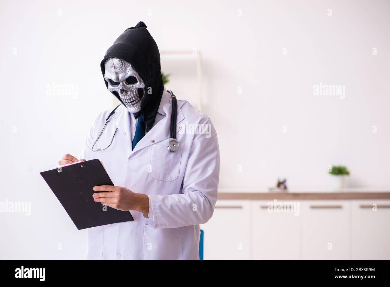 Male devil doctor working in clinic Stock Photo - Alamy