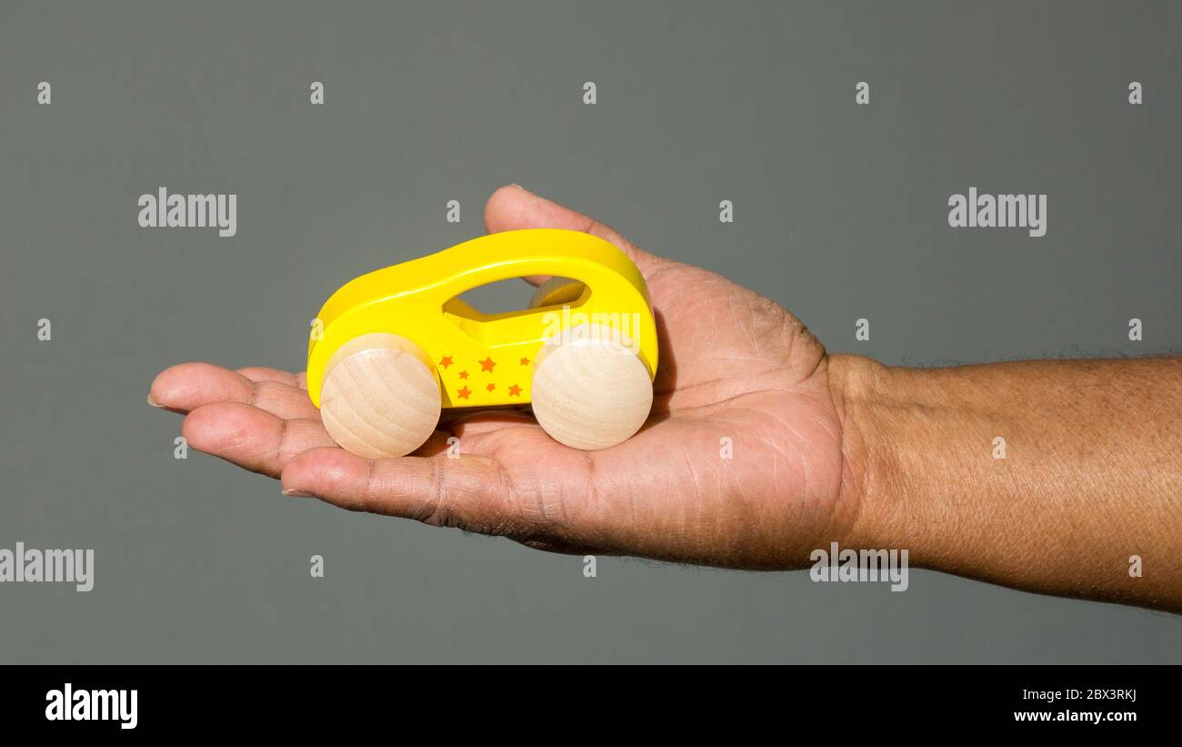 Male hand holding toy hi-res stock photography and images - Alamy