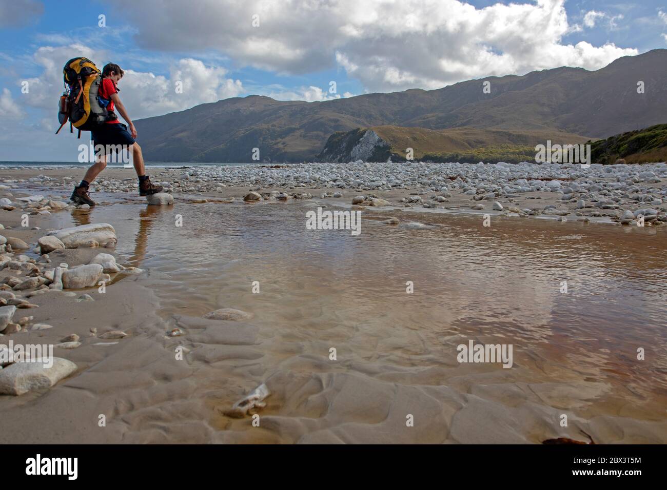 South Coast Track hiker crossing a stream on Cox Bight Stock Photo - Alamy