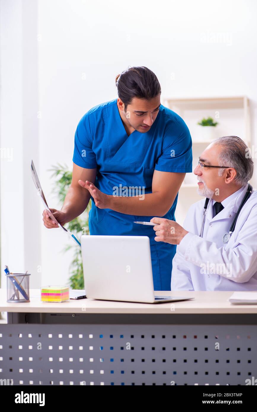 Two male doctors working in the modern clinic Stock Photo - Alamy