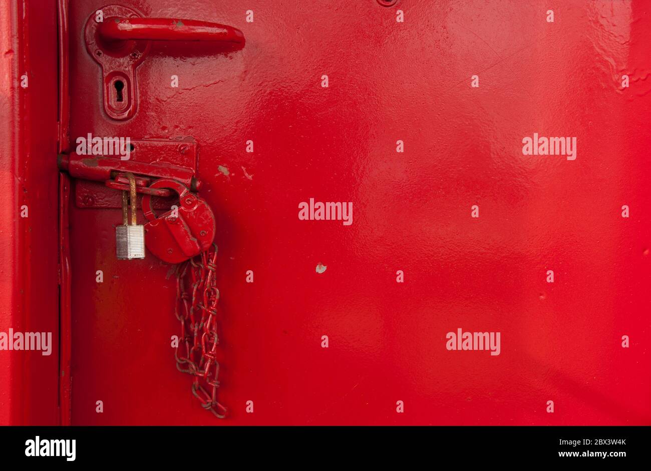 Two lock secure a red door Stock Photo - Alamy