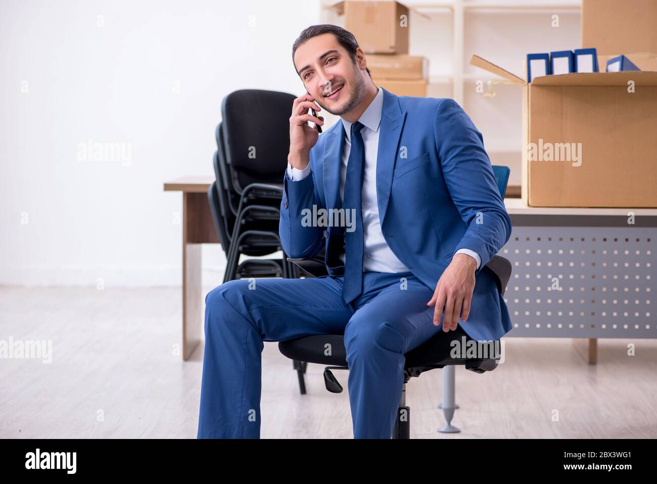 Young employee in relocation concept Stock Photo - Alamy