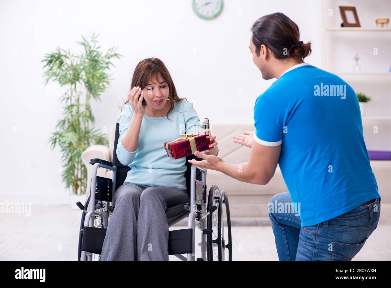Disabled wife and husband at home Stock Photo - Alamy