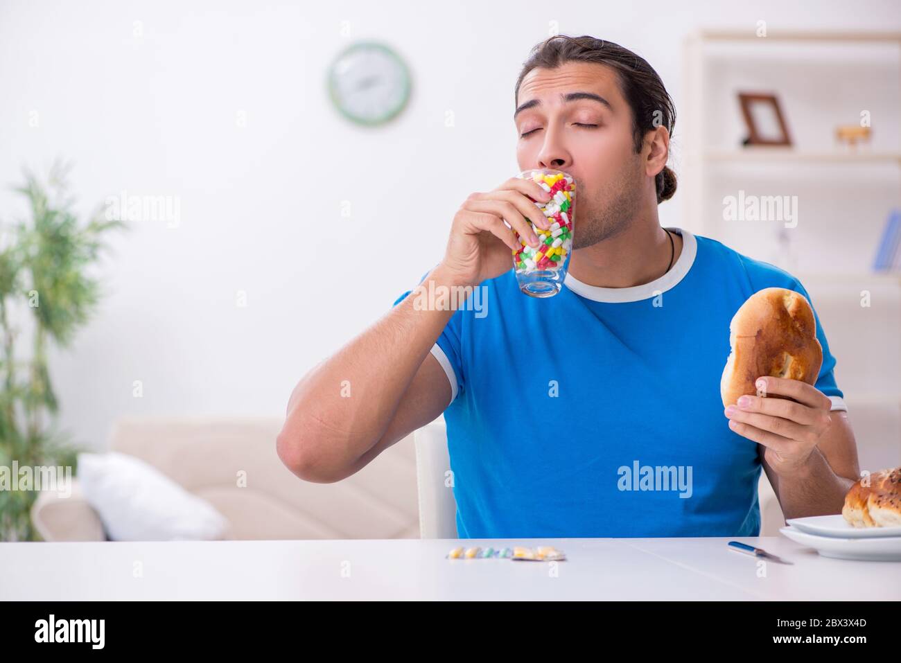 Young hungry man in the dieting concept Stock Photo - Alamy