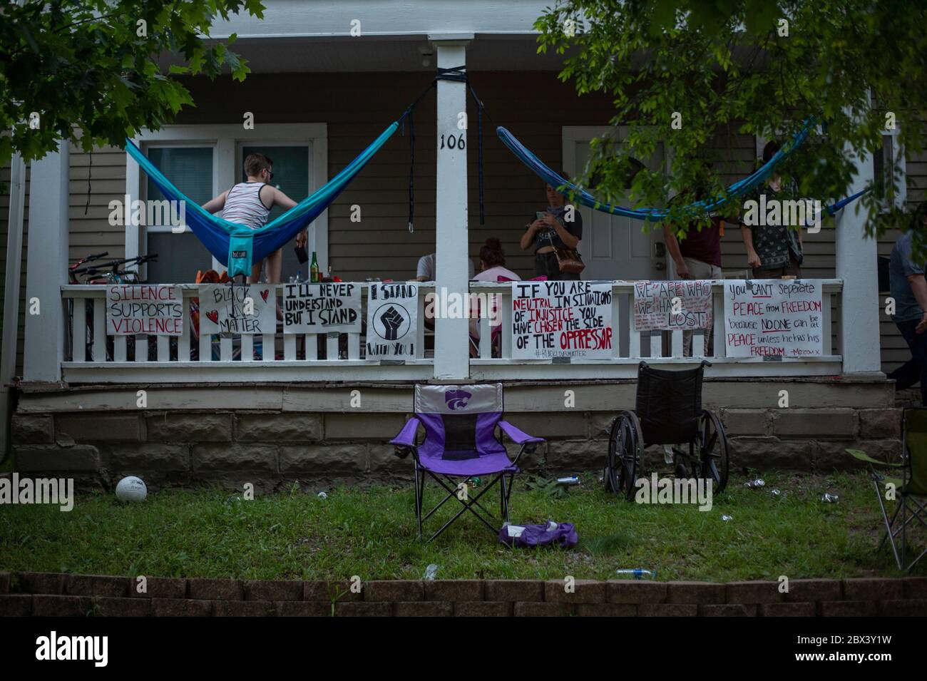 Manhattan, Kansas, USA. 3rd June, 2020. Signs hang on a porch railing ...