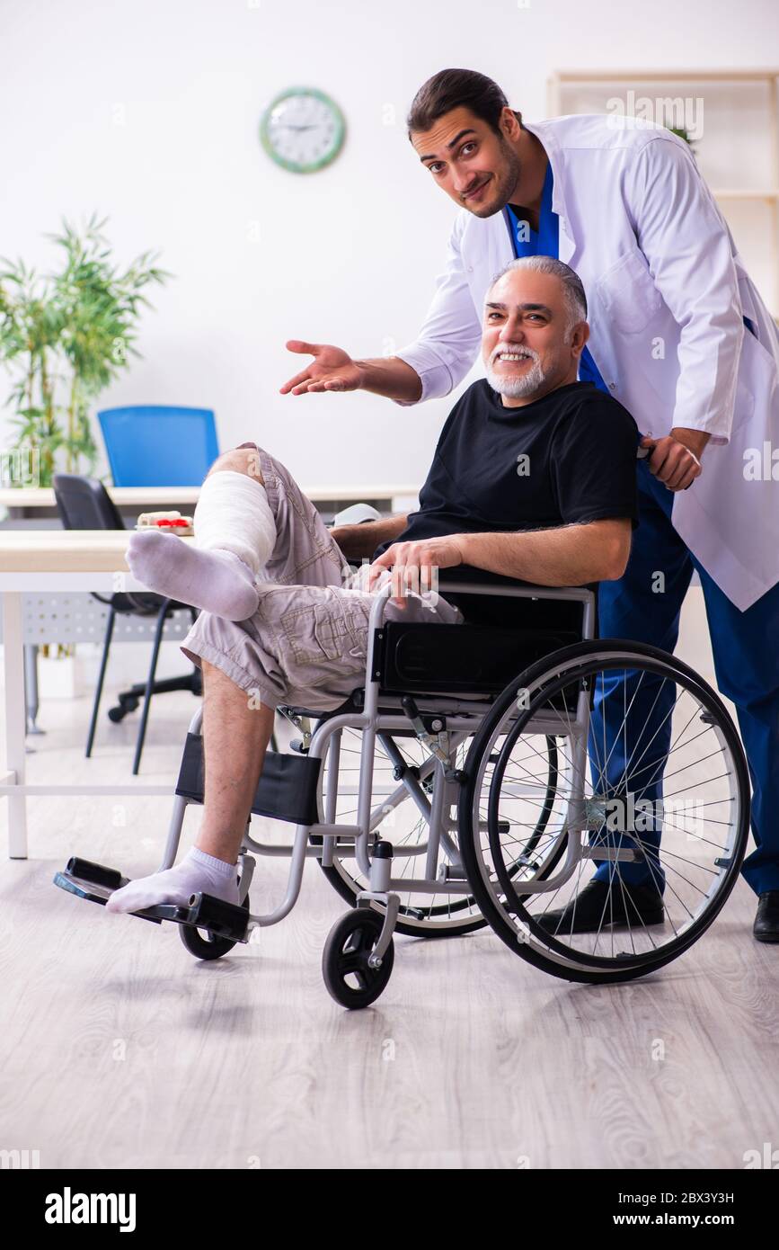Old injured man visiting young doctor traumatologist Stock Photo - Alamy