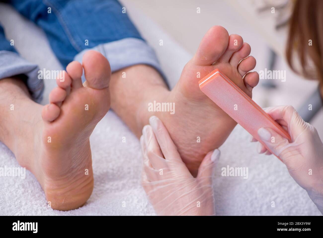 Podiatrist massaging leg patient hi-res stock photography and images ...