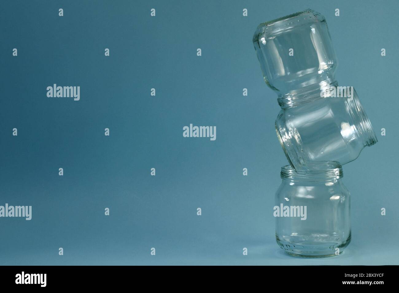 Vertical curve row of glass jars on the right on a blue background ...