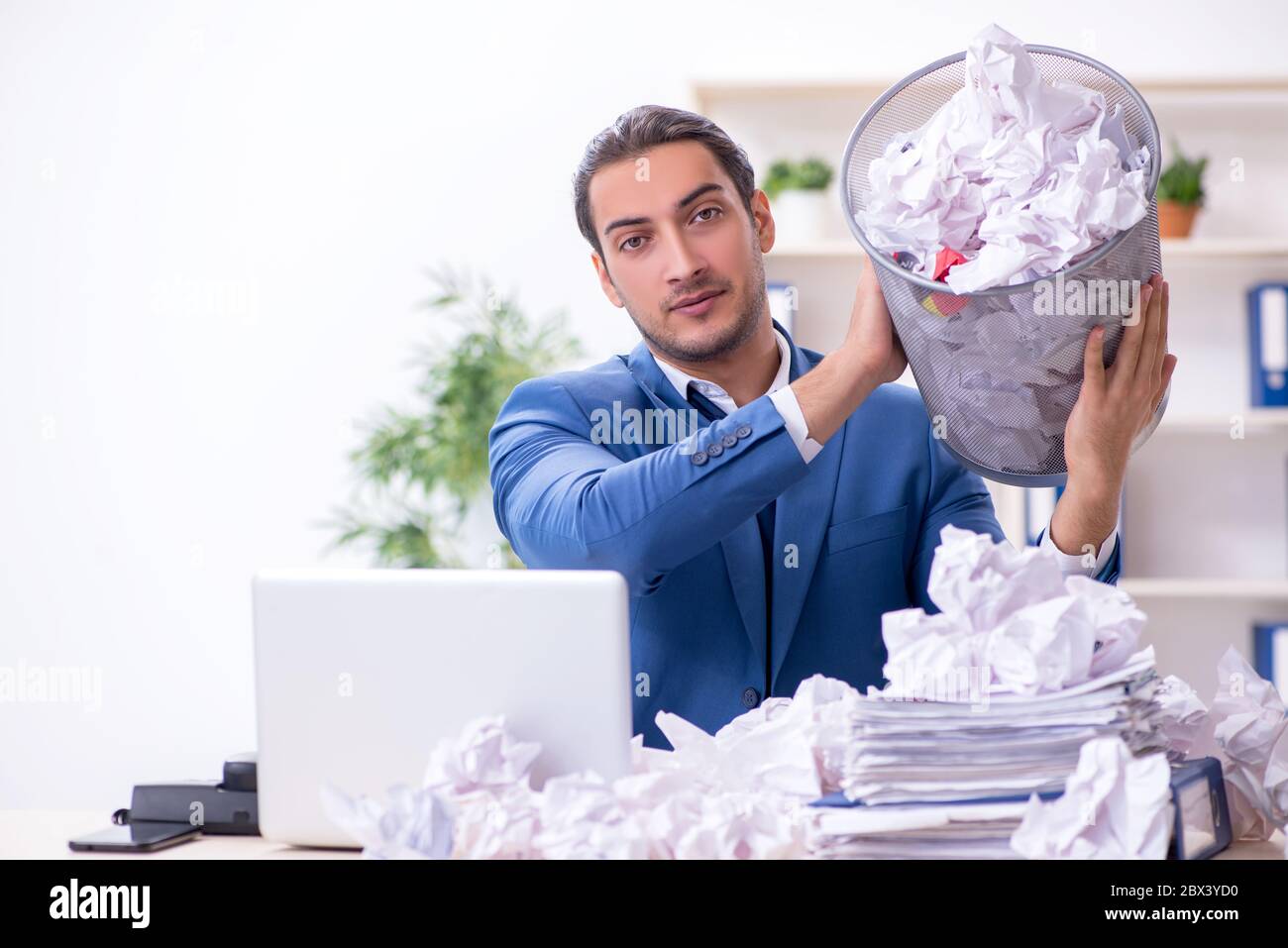 Businessman rejecting ideas with lots of papers Stock Photo - Alamy