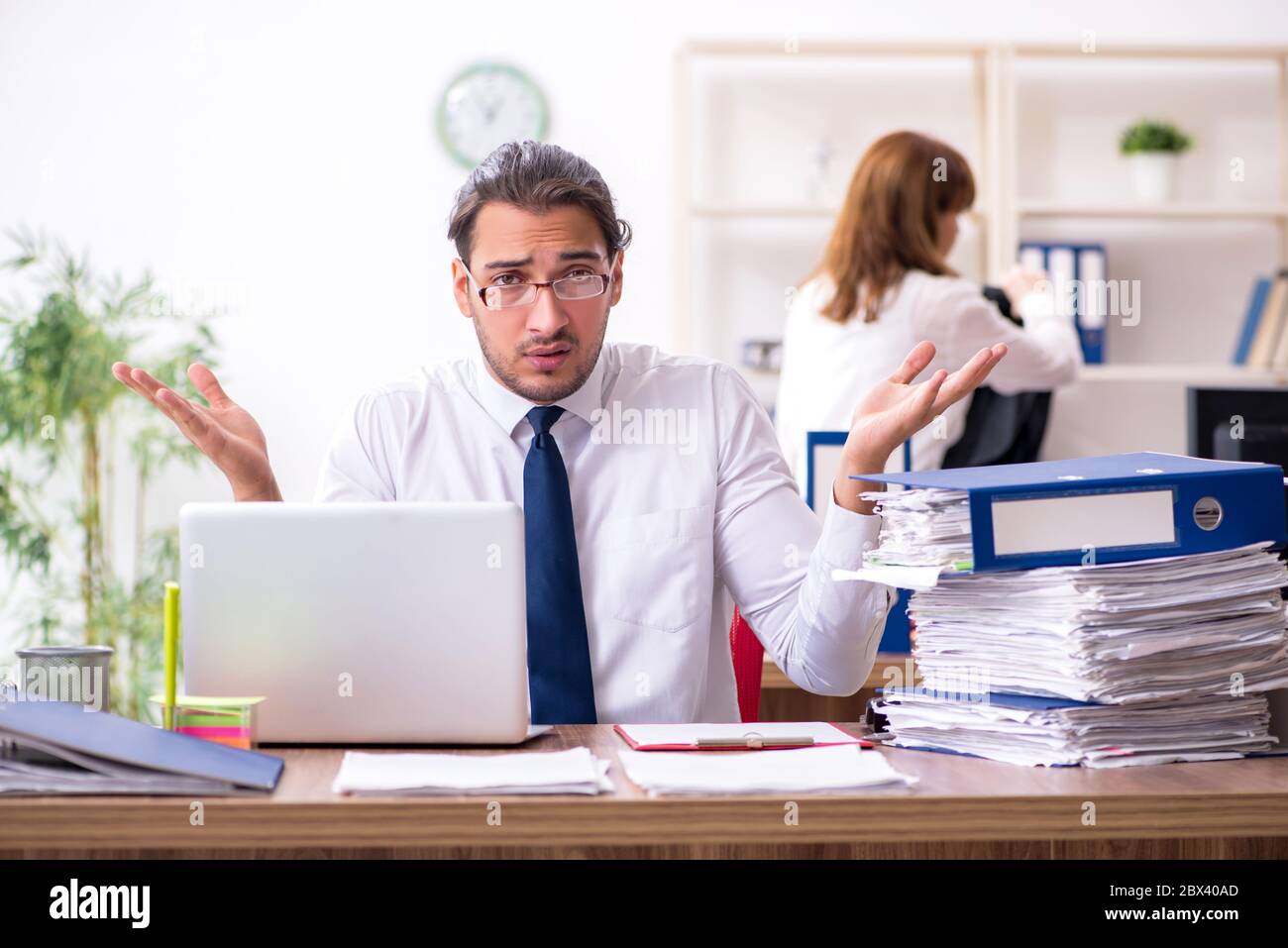 Two employees working in the office environment Stock Photo - Alamy