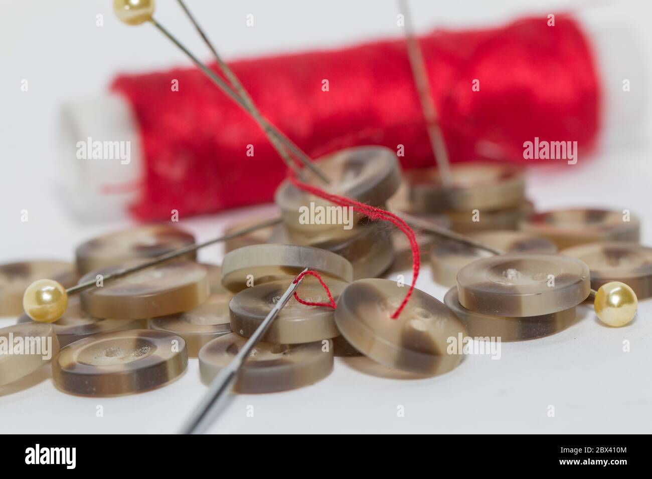 Needle with thread and button isolated on white , needlework and ...