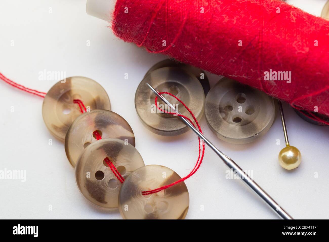 Needle with thread and button isolated on white , needlework and ...