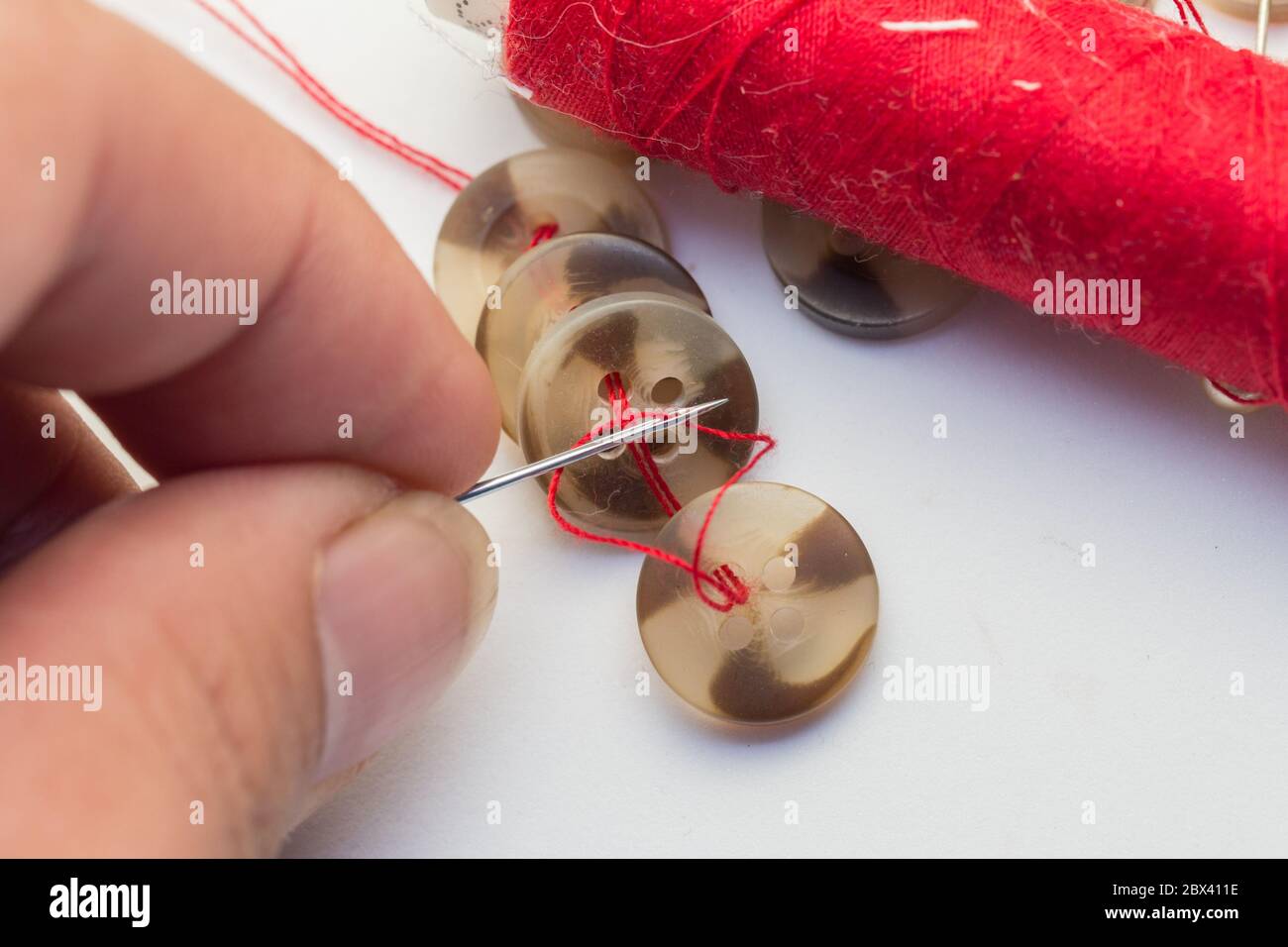Needle with thread and button isolated on white , needlework and ...