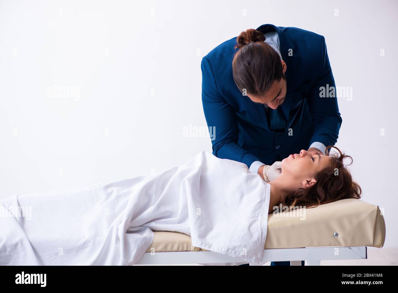 Police coroner examining dead body in morgue Stock Photo - Alamy