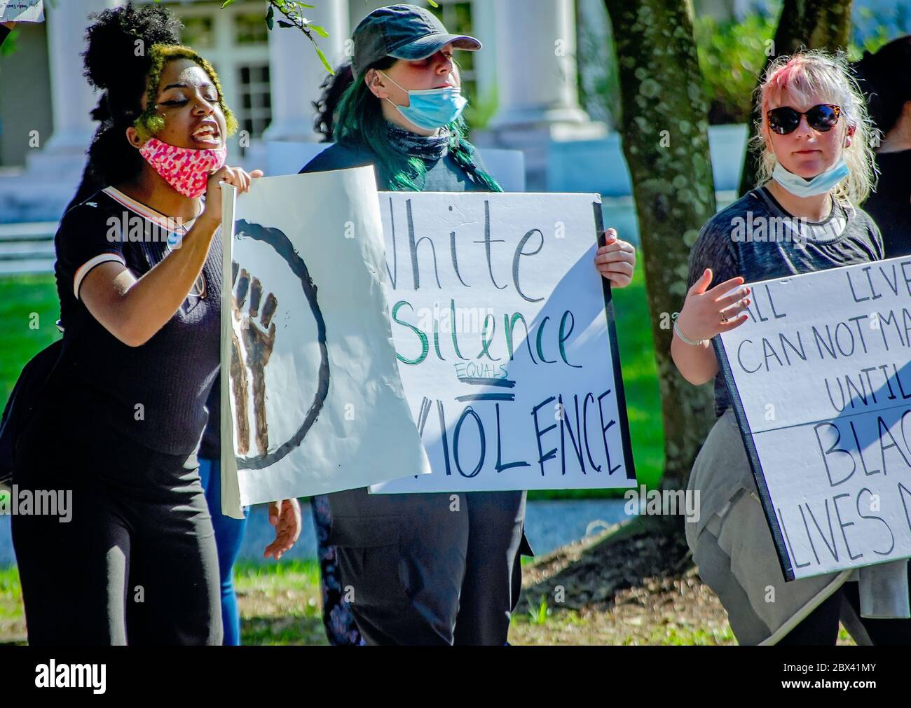 Protestors wave signs while at a protest against police brutality, June ...