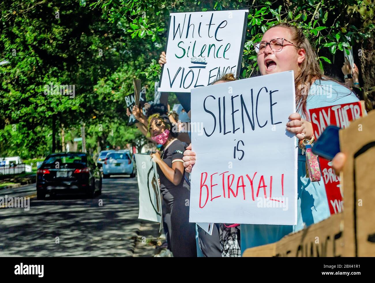 Protestors wave signs while at a protest against police brutality, June ...