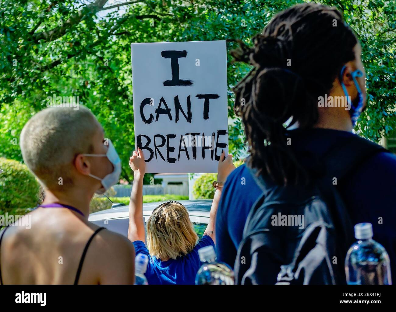 Protestors wave signs while at a protest against police brutality, June ...