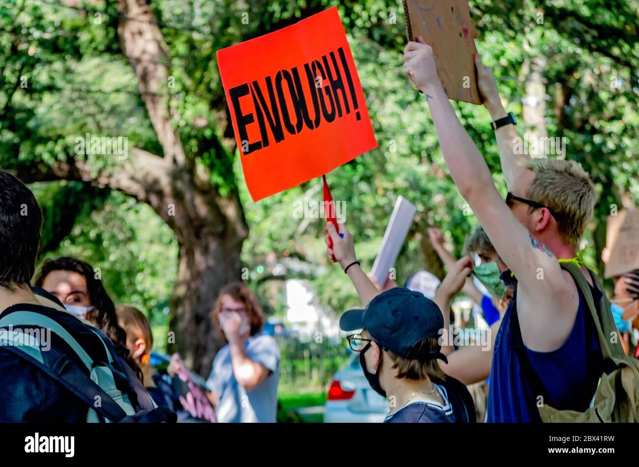 Protestors wave signs while at a protest against police brutality, June ...