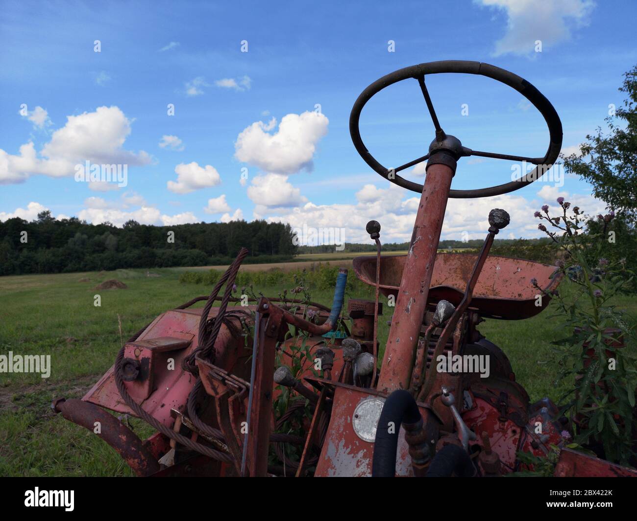 Rusting, derelict old tractor abandoned in farmland meadow Stock Photo ...