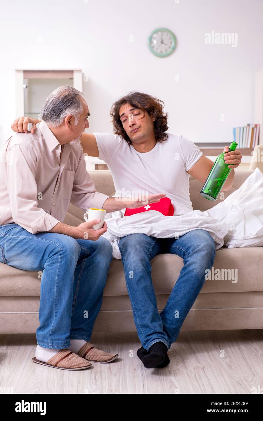 Drinking problems in the family between son and father Stock Photo - Alamy