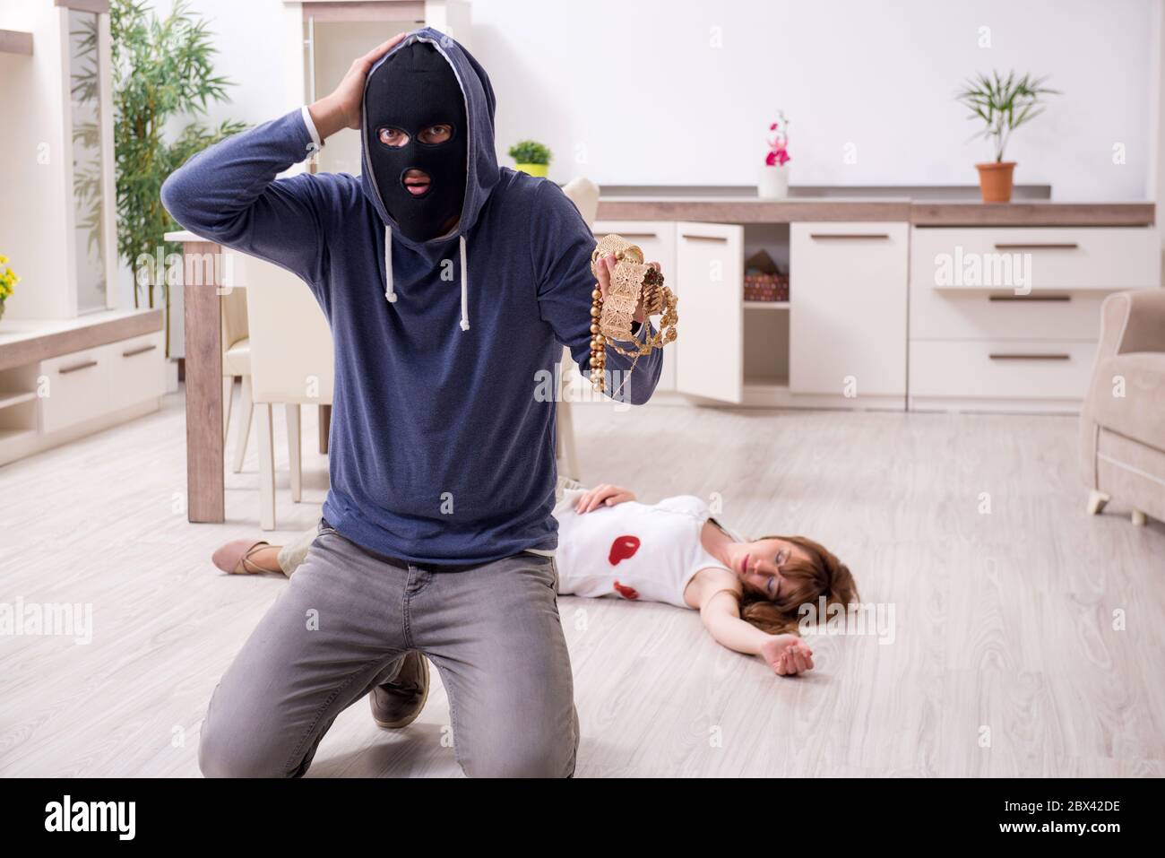 Gangster and woman in robbery concept Stock Photo - Alamy
