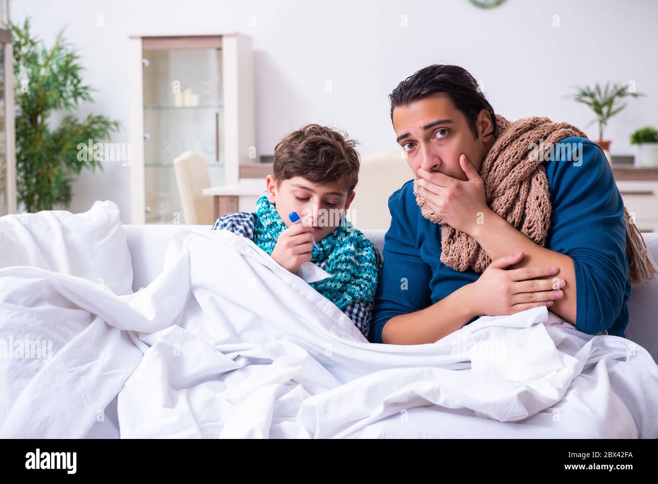 The young father caring for sick son Stock Photo - Alamy