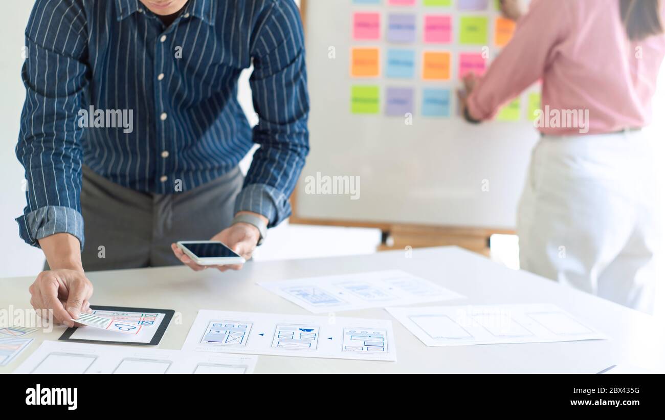 Graphic designers team work together with UX UI designer planning ...