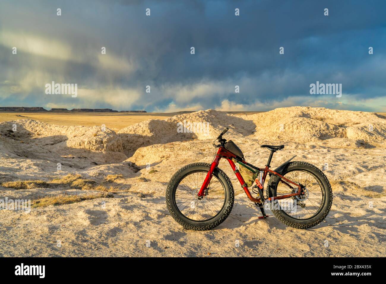 mountain fat bike in badlands with storm clouds in background - Main ...