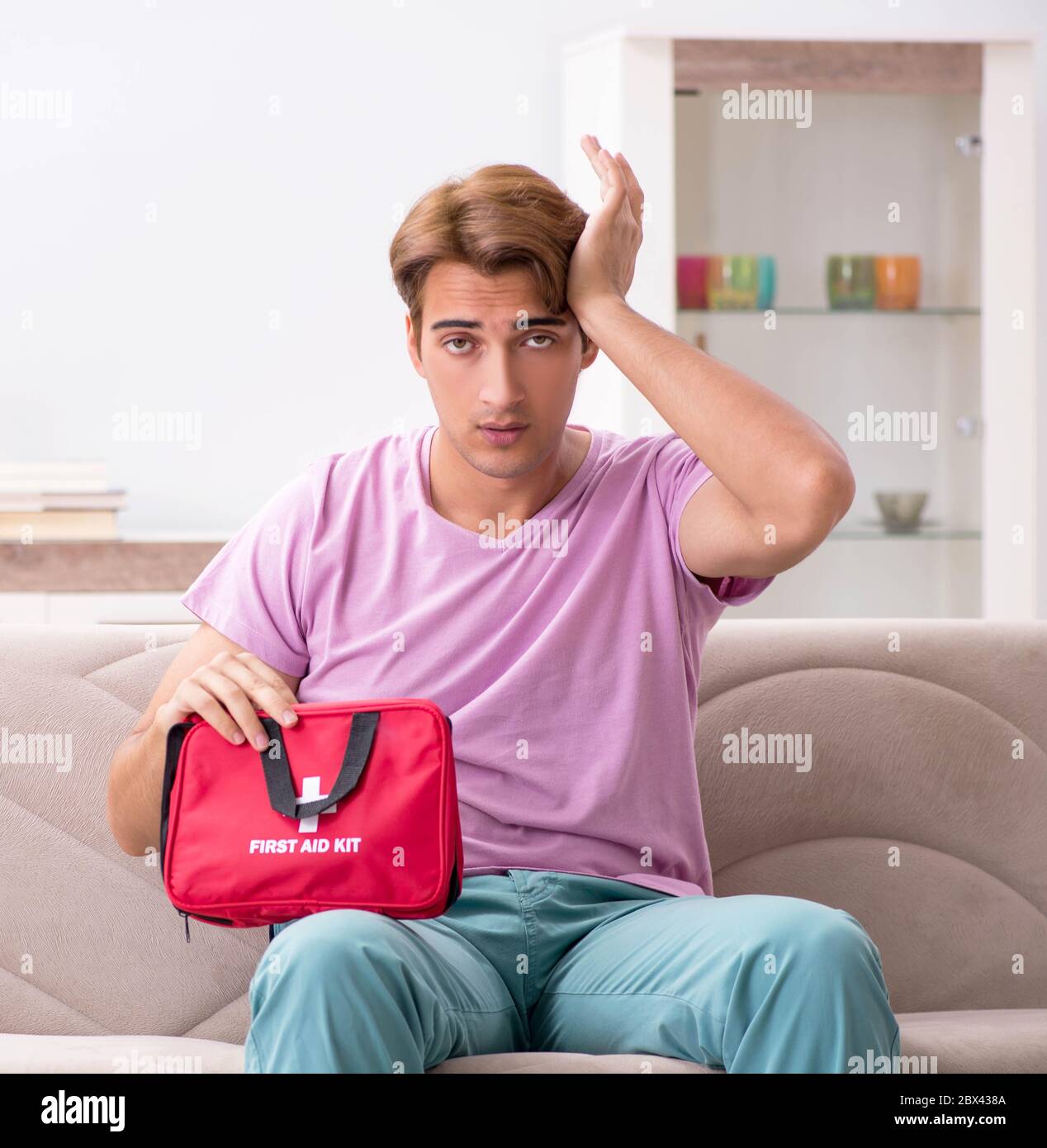 The sick man at home with first aid kit Stock Photo - Alamy