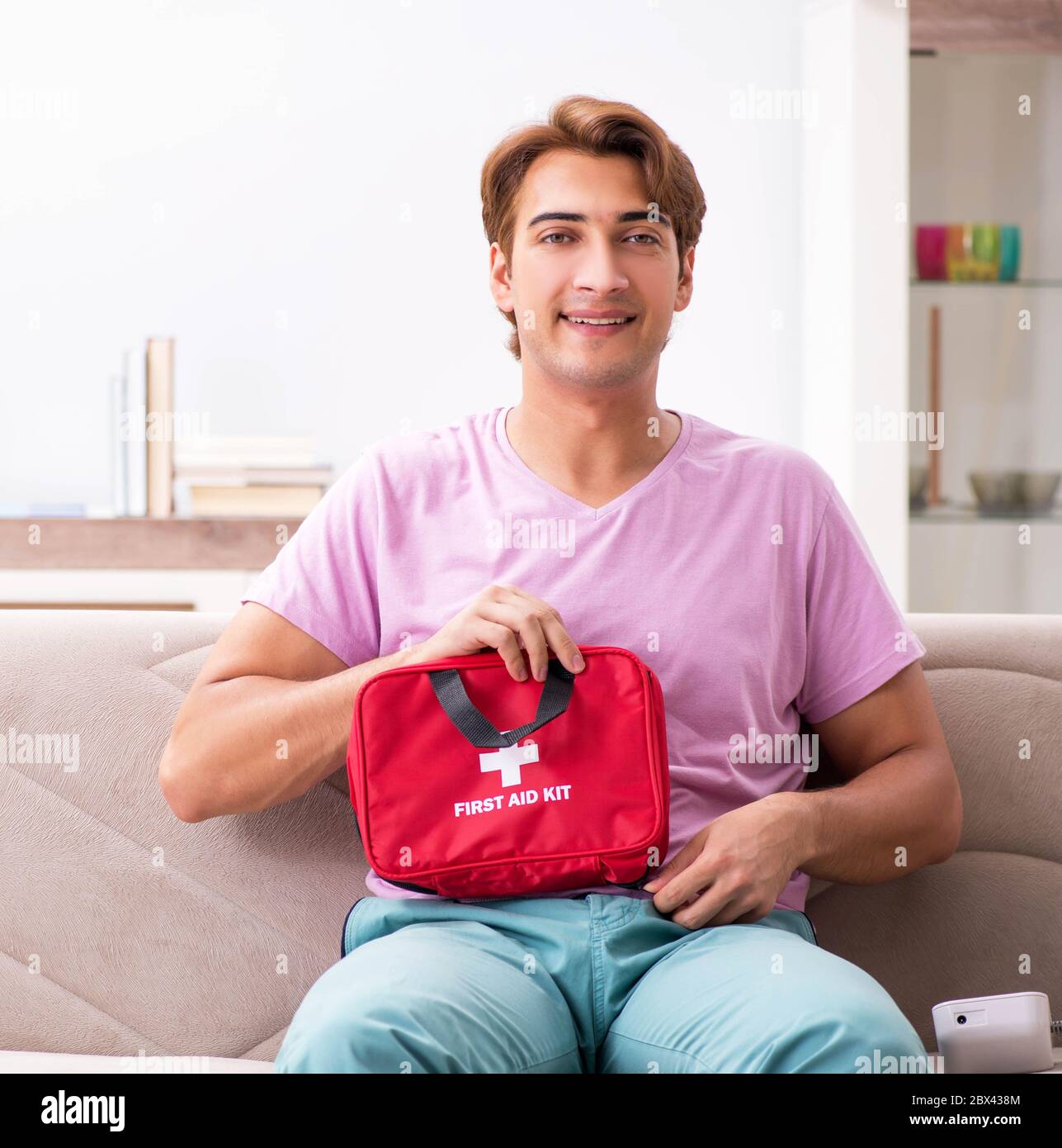 The sick man at home with first aid kit Stock Photo - Alamy