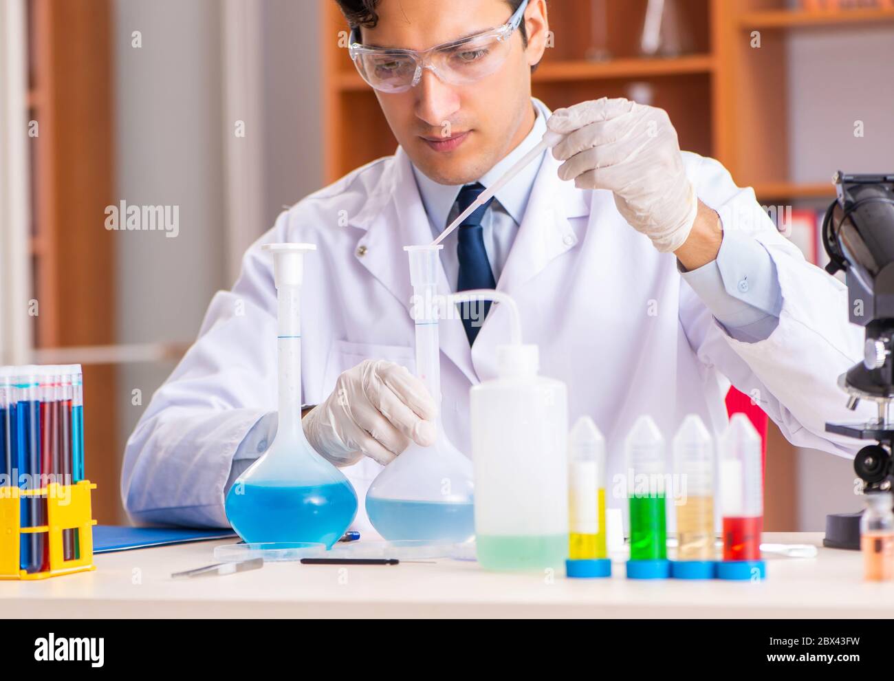 The young handsome biochemist working in the lab Stock Photo - Alamy