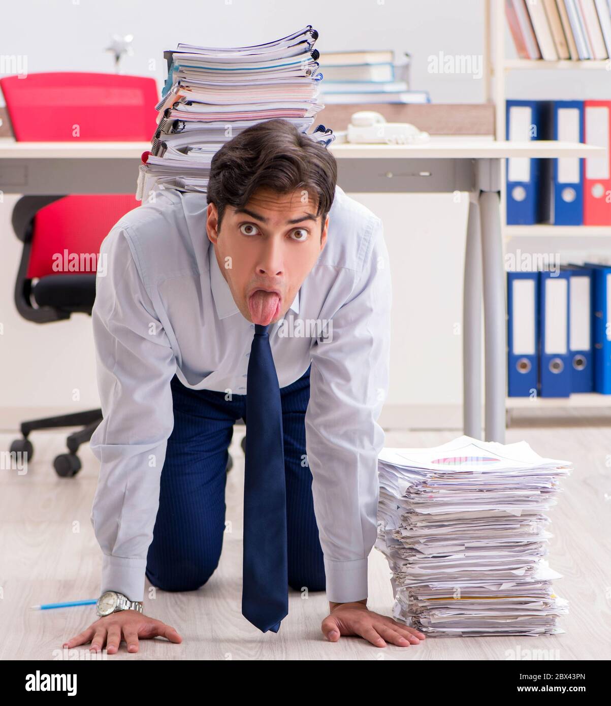 The extremely busy employee working in the office Stock Photo - Alamy