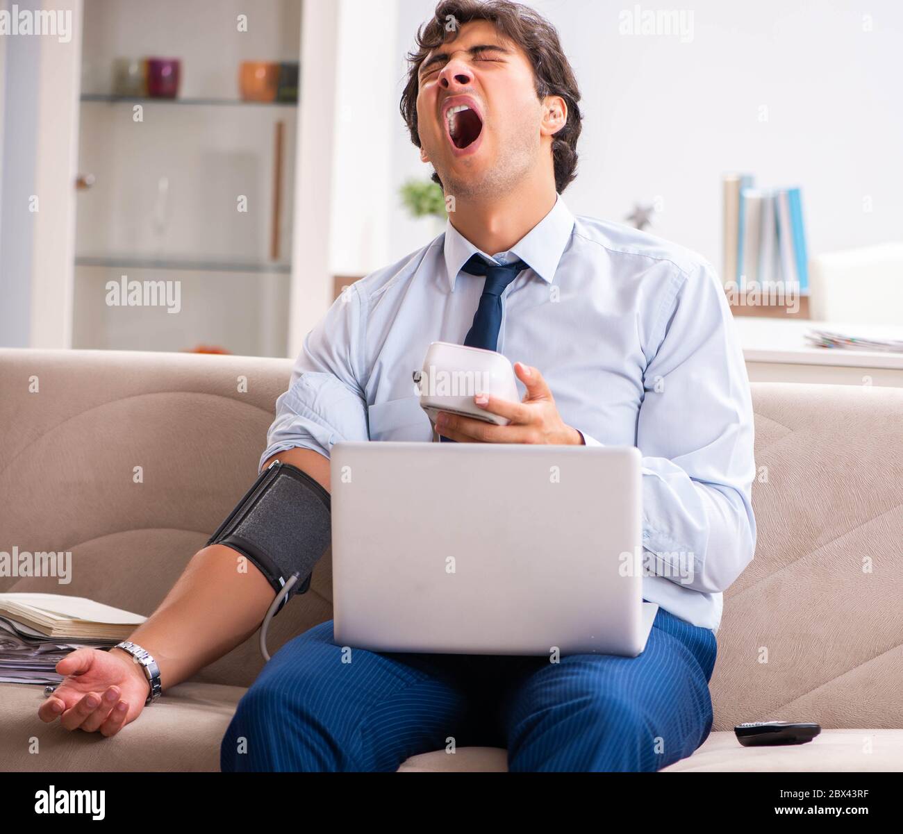 The man under stress measuring his blood pressure Stock Photo - Alamy
