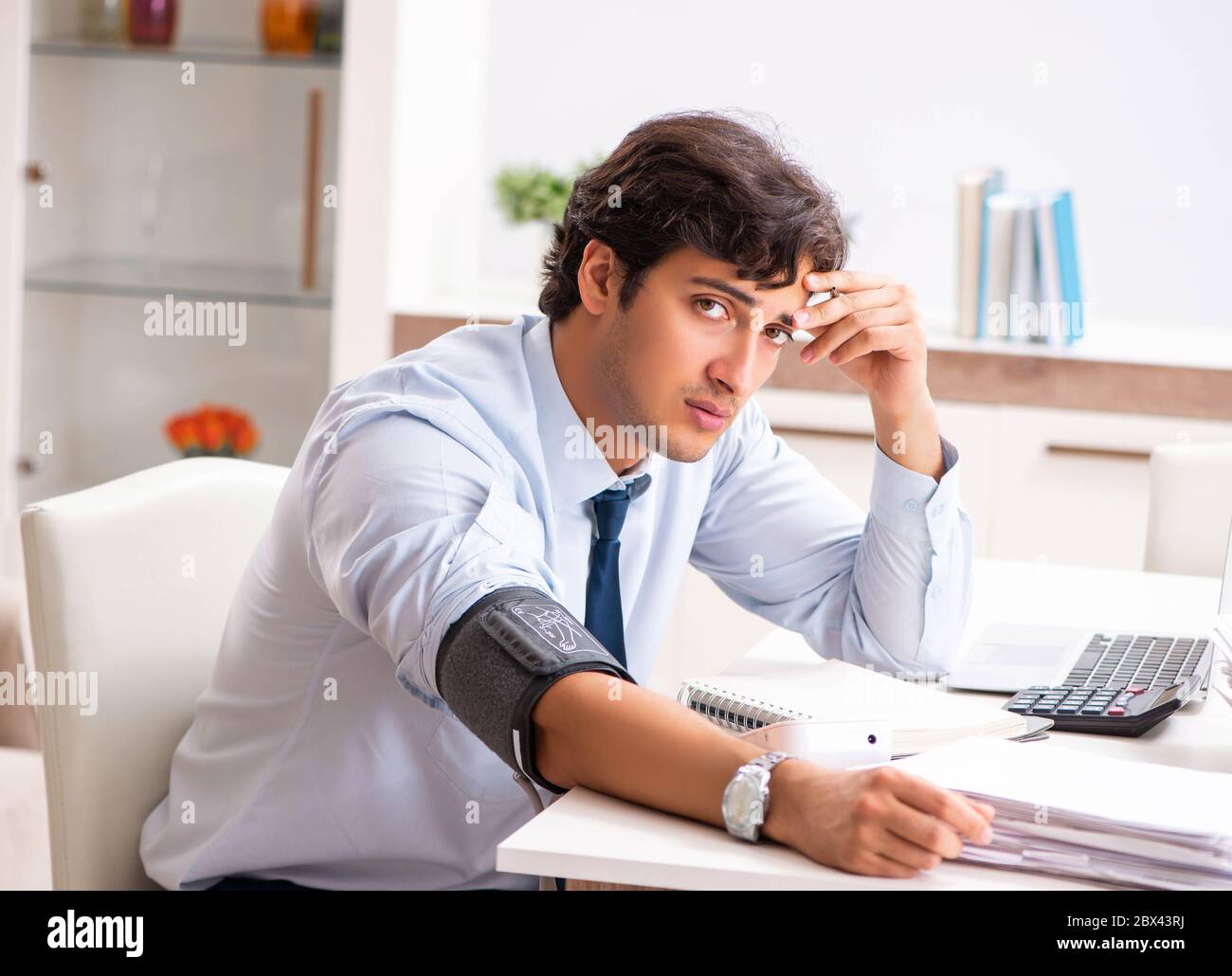 The man under stress measuring his blood pressure Stock Photo - Alamy
