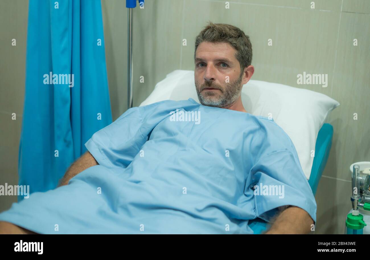 scared and worried man hospitalized - attractive injured man lying on ...