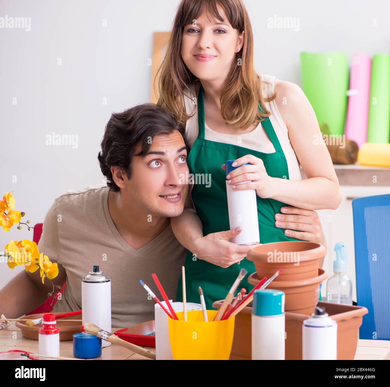 The couple decorating pots in workshop during class Stock Photo - Alamy