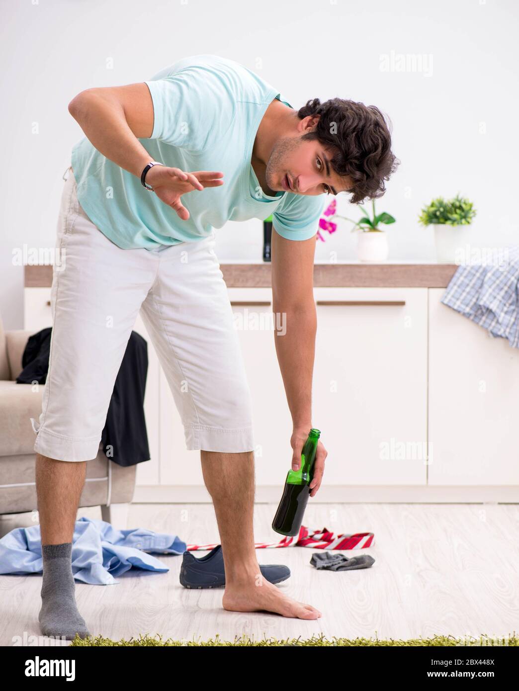 The young drunk handsome man after party at home Stock Photo - Alamy