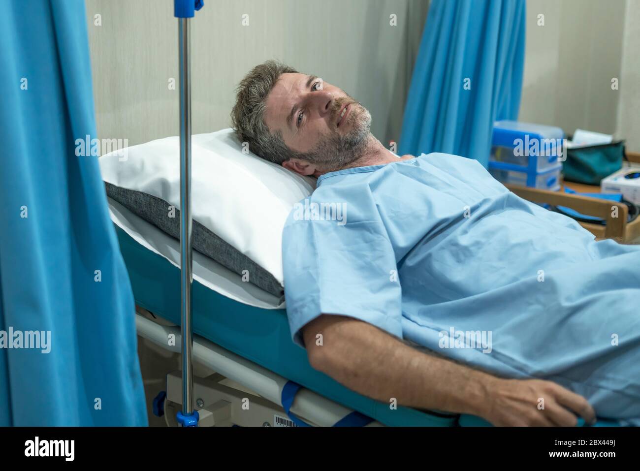 scared and worried man in pain at hospital room - attractive injured ...