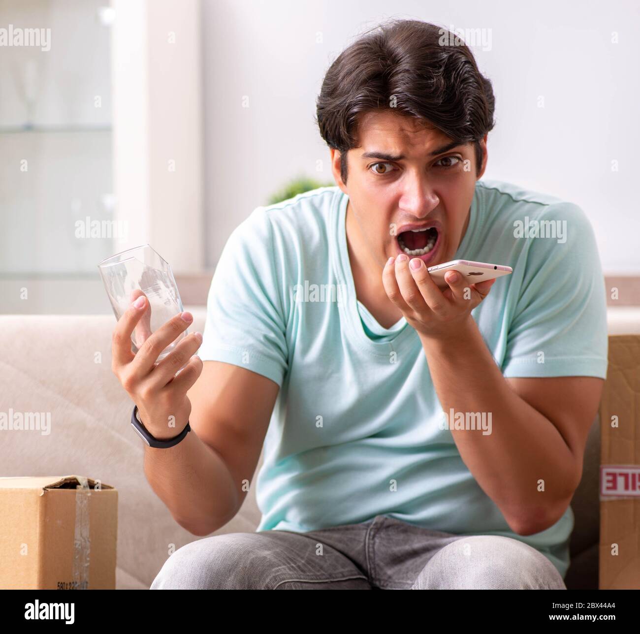 The man opening fragile parcel ordered from internet Stock Photo - Alamy